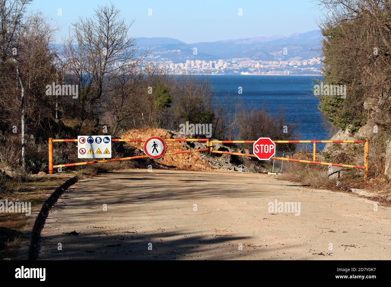 Locked and closed red and yellow partially rusted old metal ramp with ...
