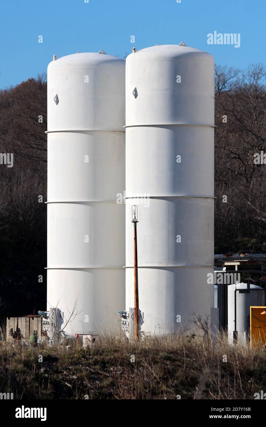 Two brand new white storage silos installed at the edge of modernized ...