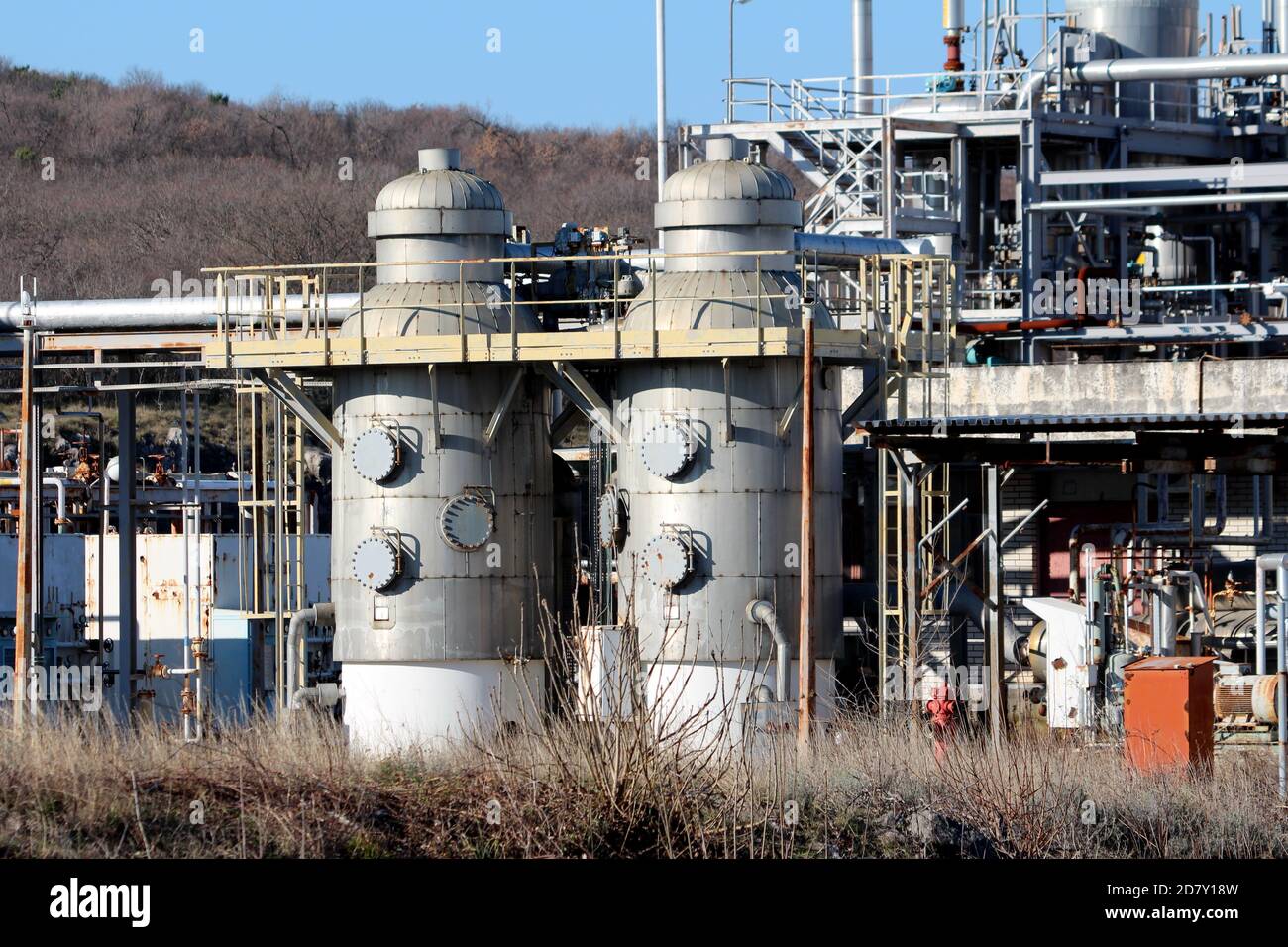 Two small strong metal storage silos with safety platform on top ...