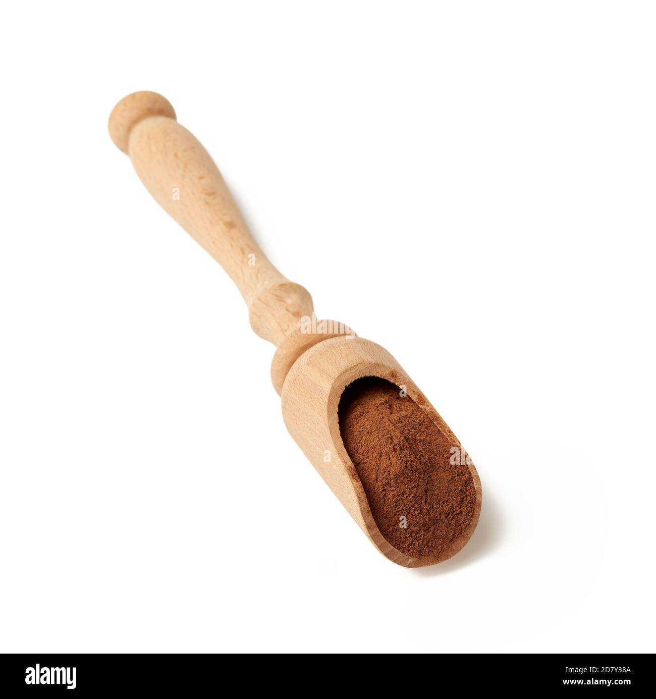 brown ground cinnamon in a wooden spoon, spice isolated on white ...