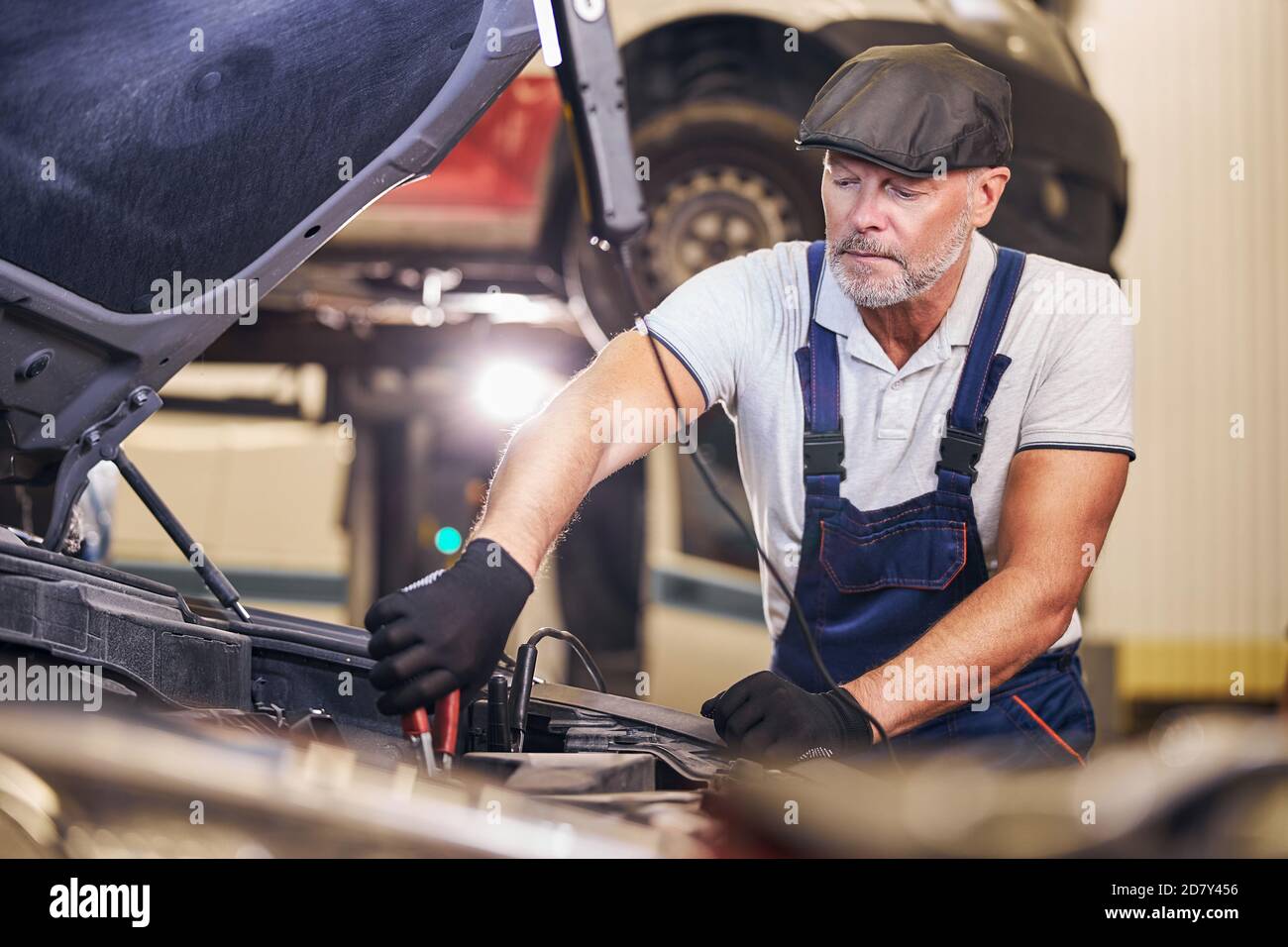 Bearded male worker fixing car engine at service station Stock Photo ...