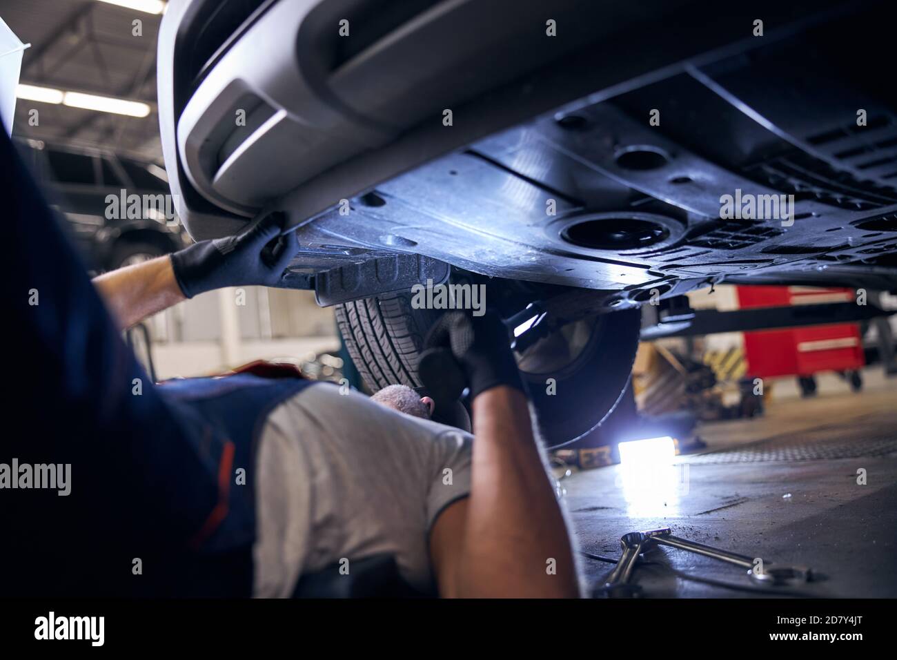 Male worker repairing car at auto service station Stock Photo - Alamy