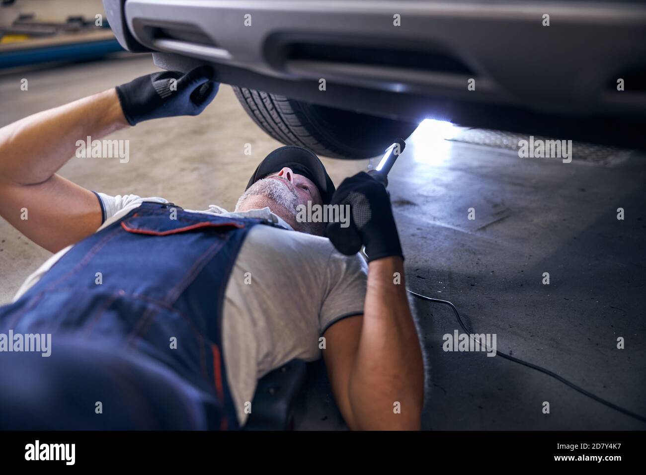 Professional auto mechanic inspecting car at service station Stock ...