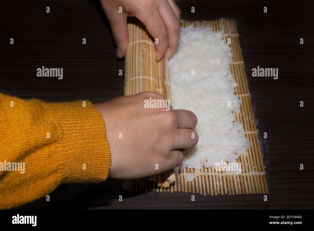 Women chef hands making sushi .Preparation of a sushi roll.Japanese ...
