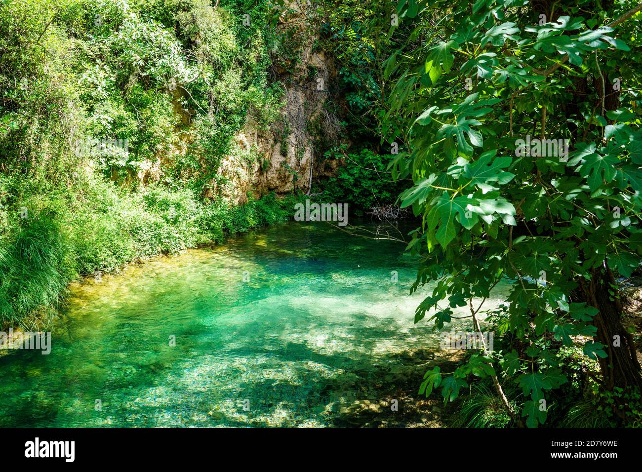 Turquoise water from a small river surrounded by rock formations and ...