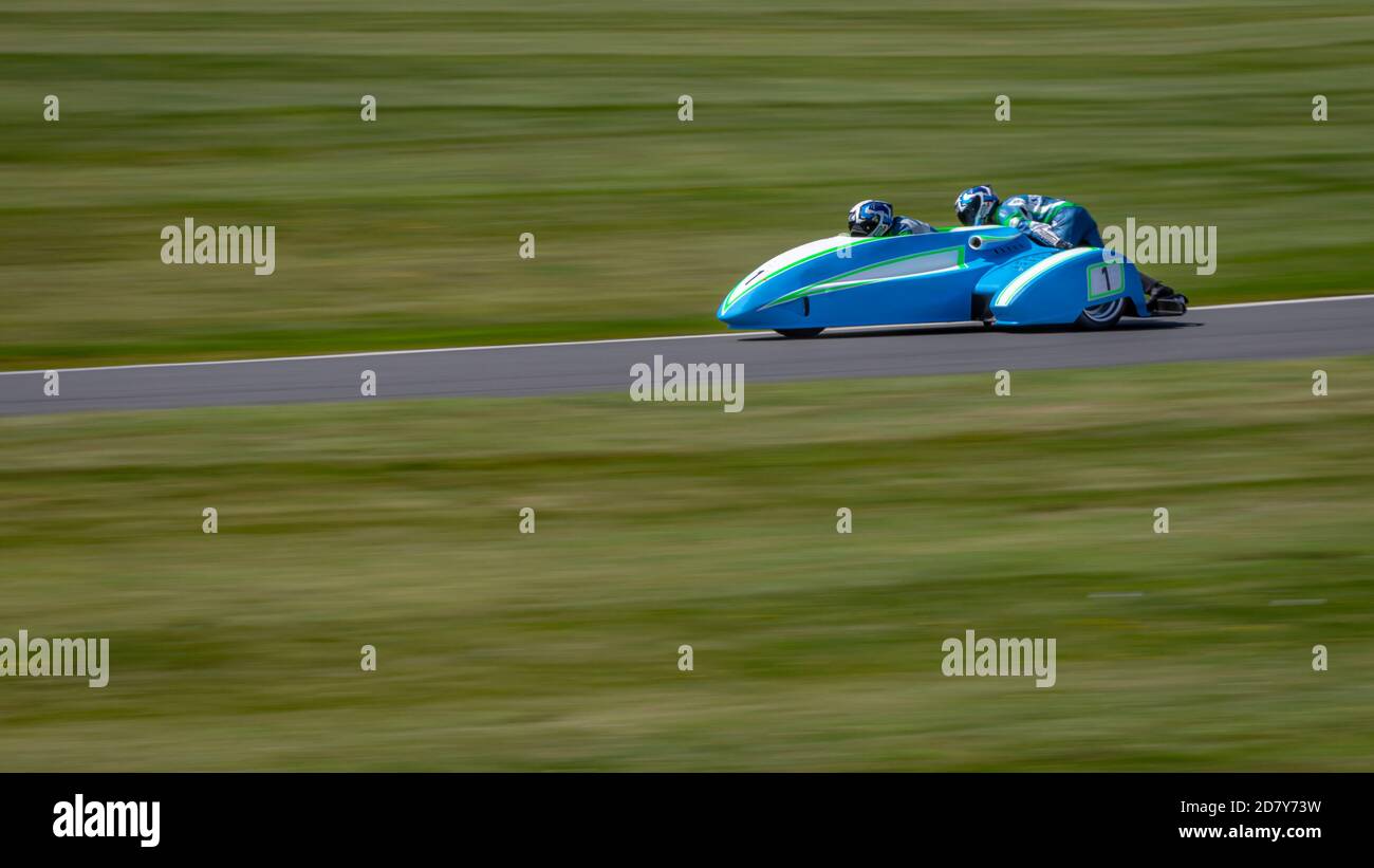 A panning shot of a racing sidecar as it corners on a track Stock Photo ...