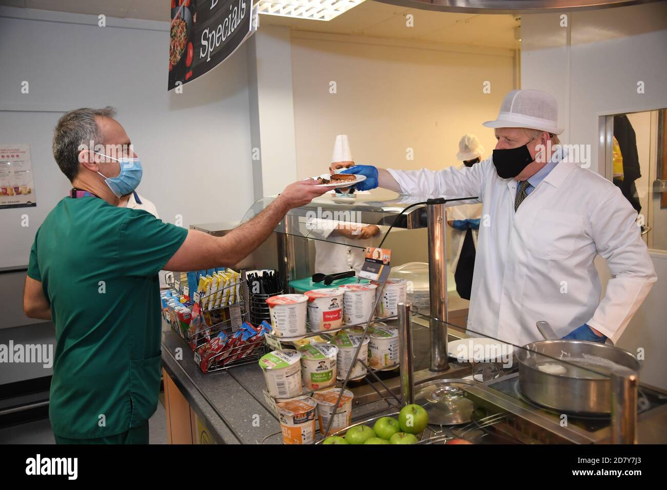 Prime Minister Boris Johnson (right) serving up a meal during a visit ...