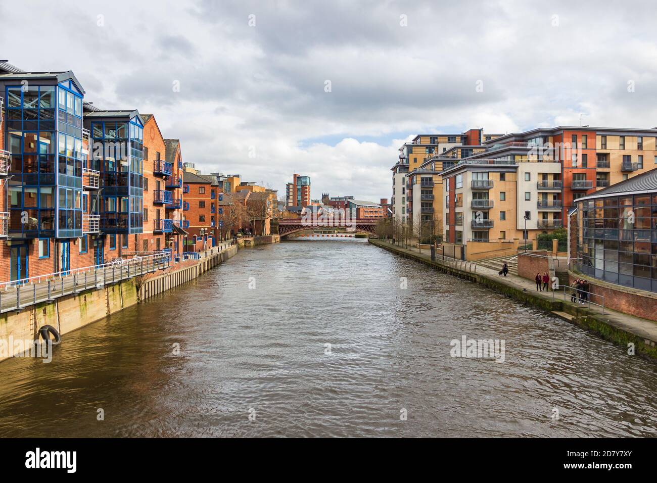 Aire river in Leeds with orange and blue buildings in a cloudy day with ...
