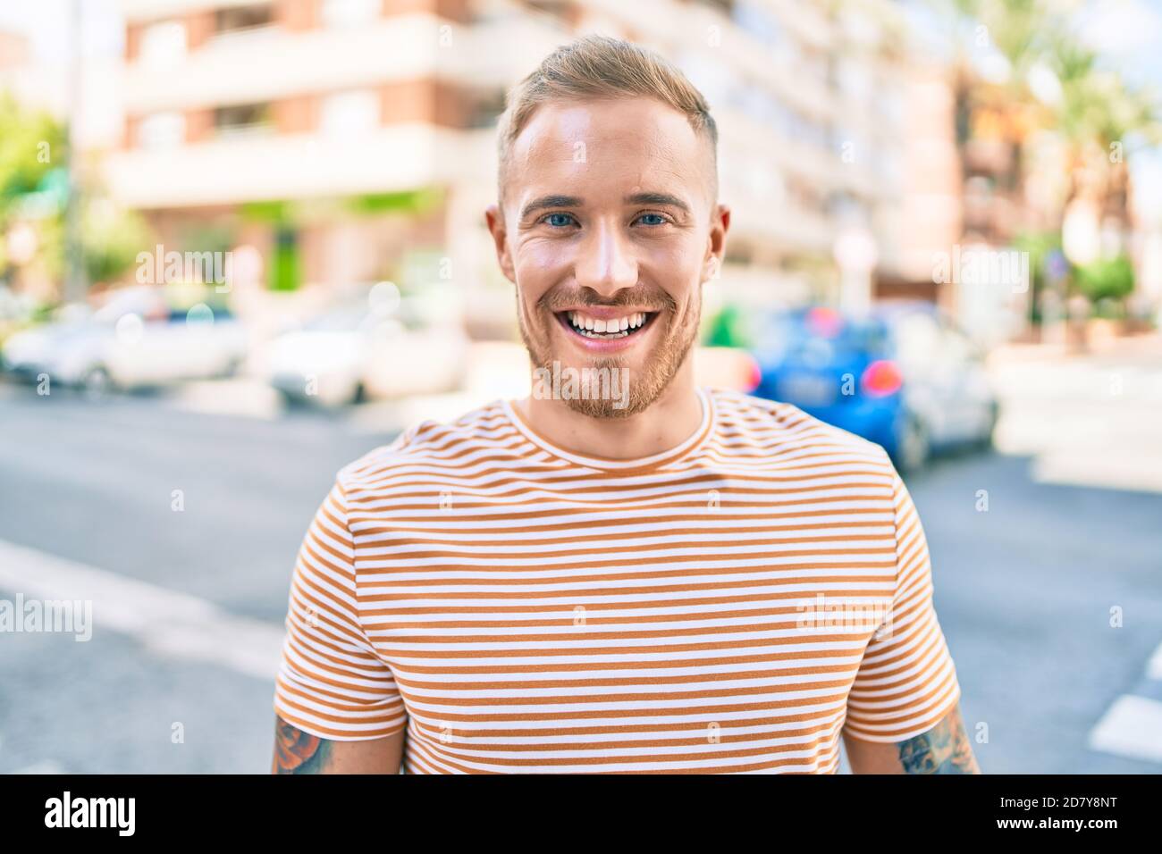 Young irish man smiling happy walking at street of city Stock Photo - Alamy