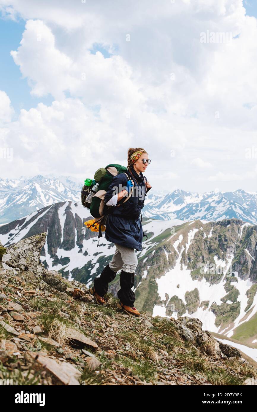 Girl Traveler hiking with backpack at rocky mountains landscape Travel ...