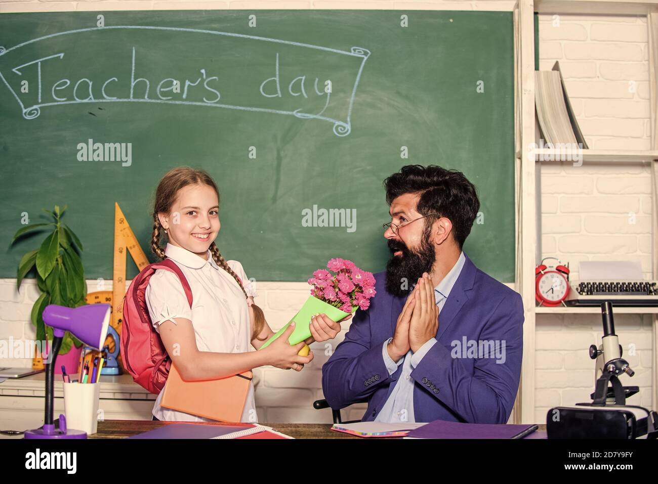 Back to school. Best wishes. Girl adorable pupil with backpack giving ...