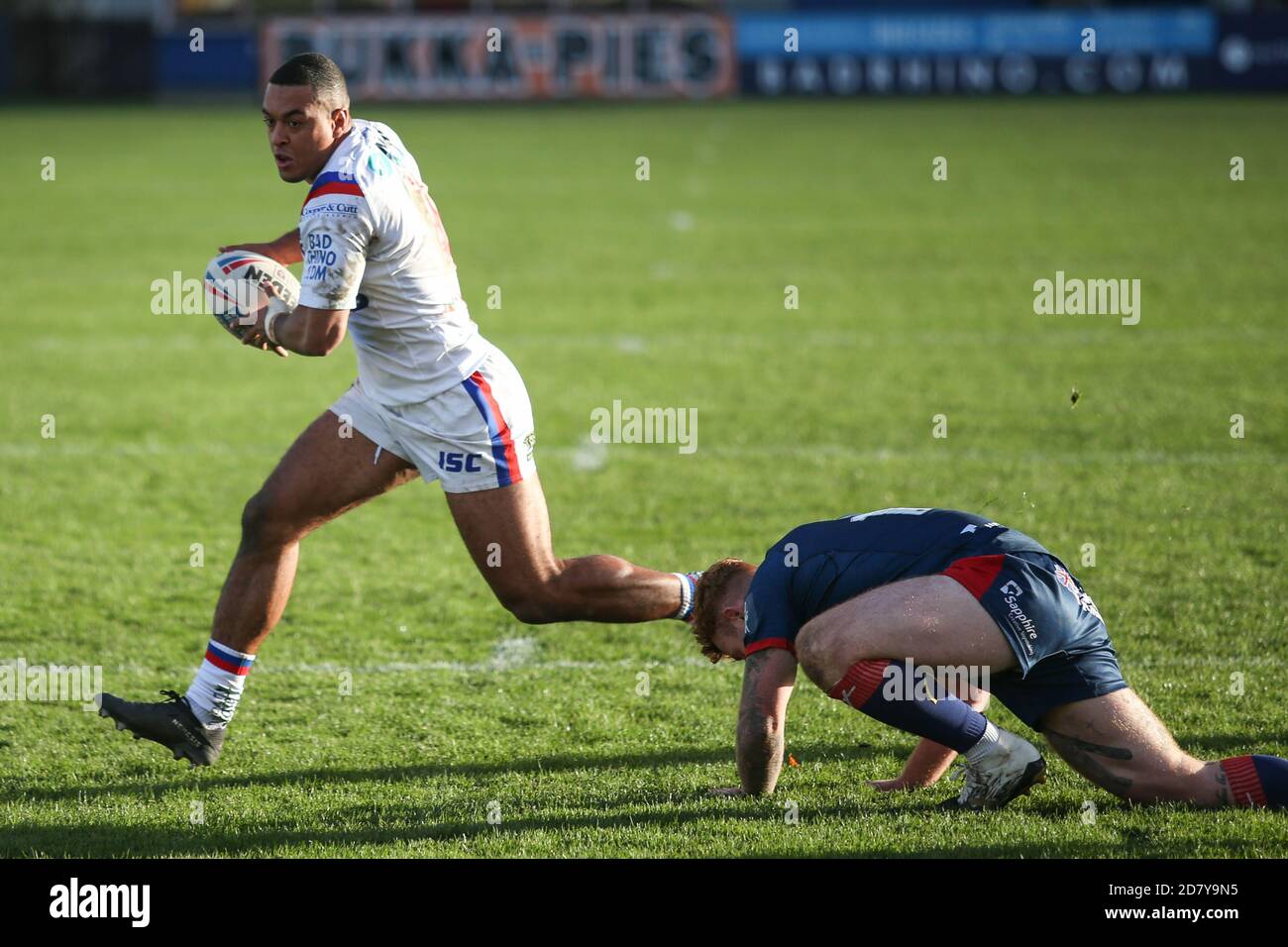 Reece Lyne (4) of Wakefield Trinity runs at Harvey Livett (12) of Hull ...