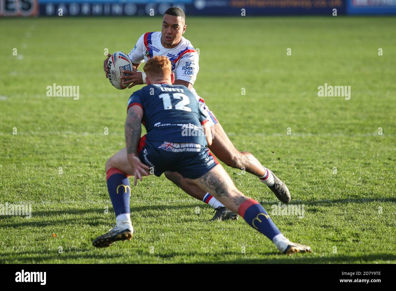 Reece Lyne (4) of Wakefield Trinity runs at Harvey Livett (12) of Hull ...
