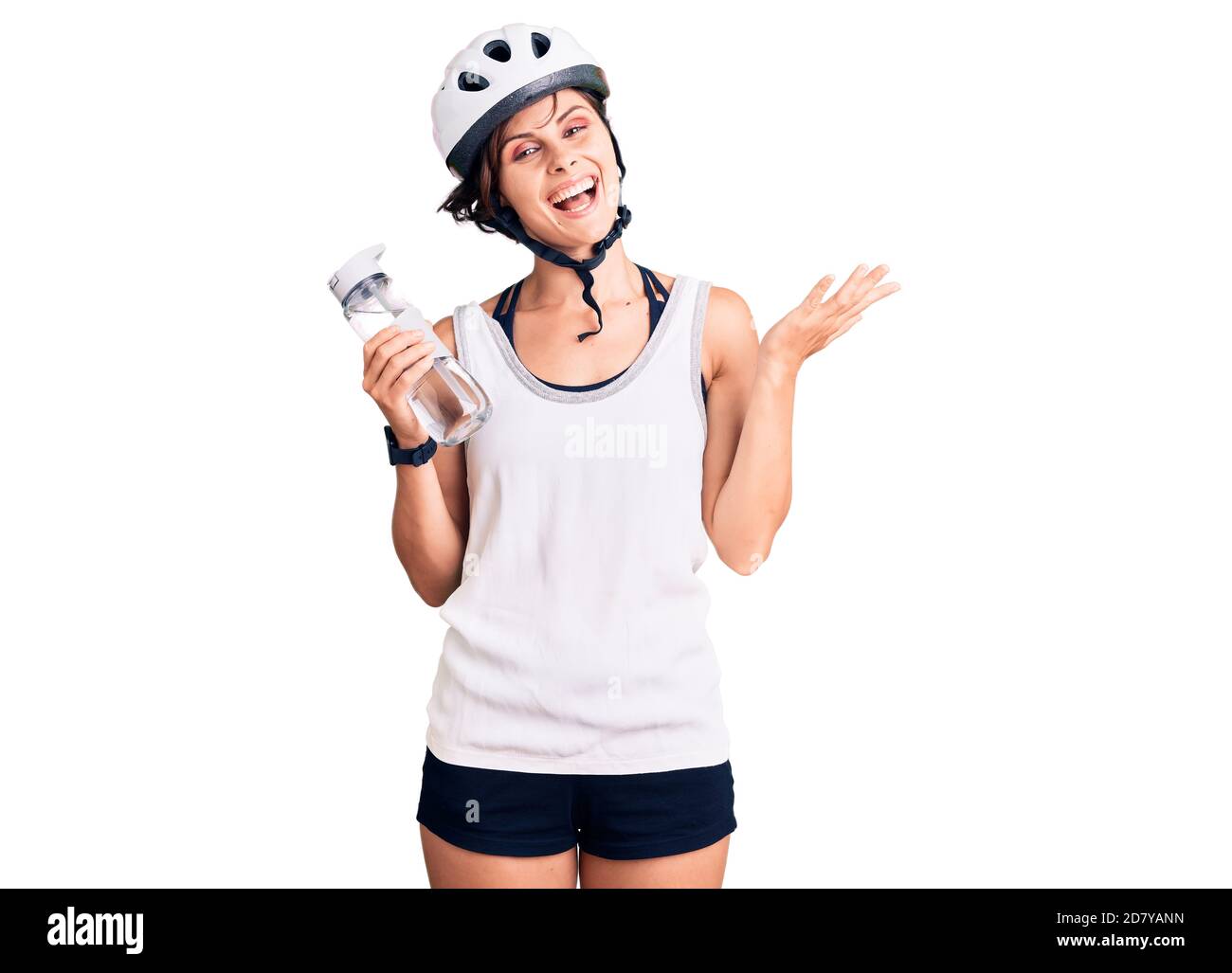 Beautiful young woman with short hair wearing bike helmet and holding ...
