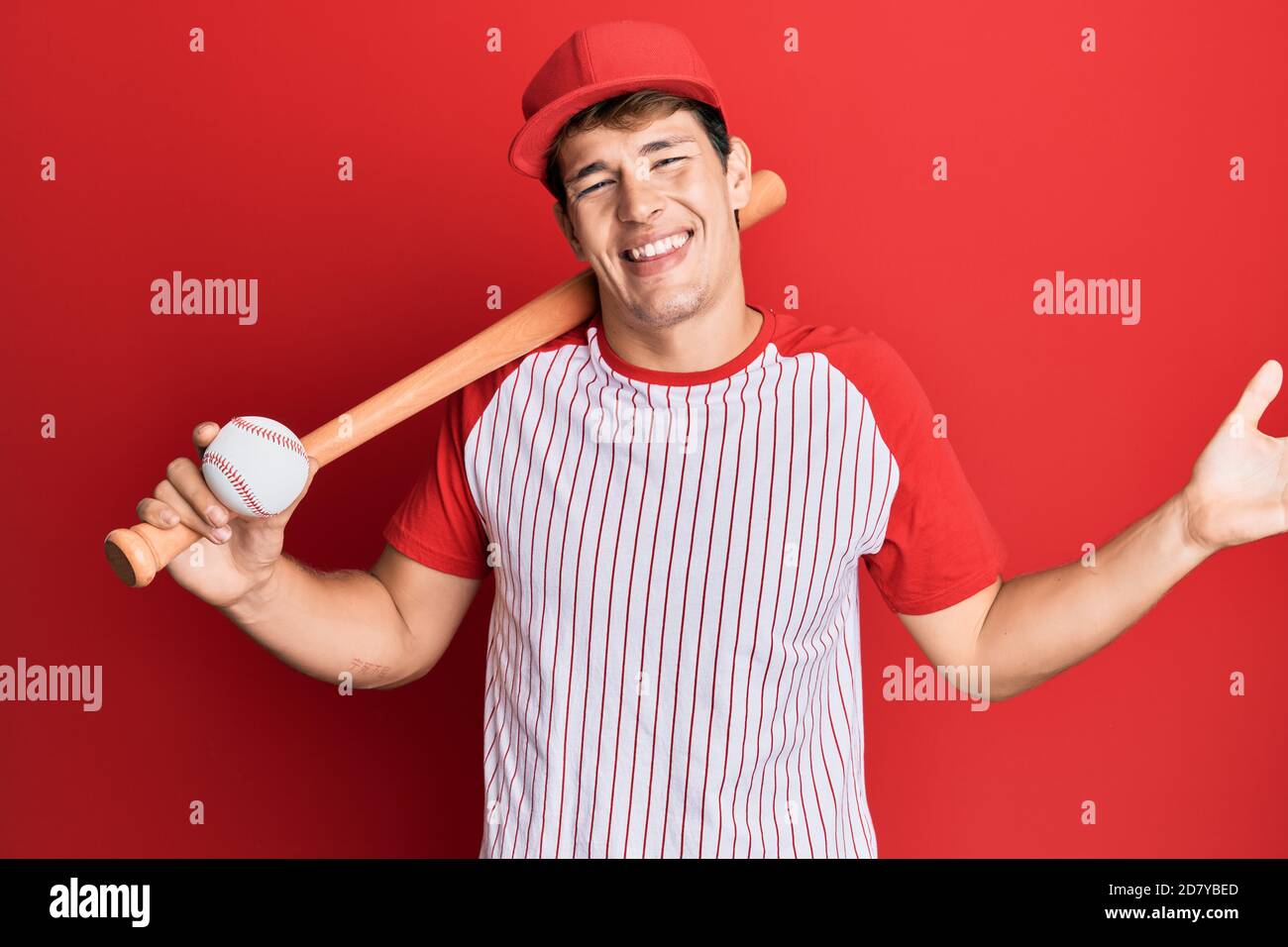 Handsome caucasian man playing baseball holding bat and ball ...