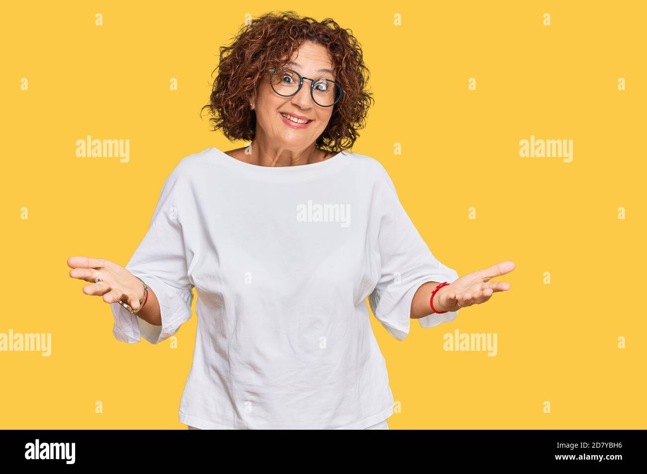 Beautiful middle age mature woman wearing casual clothes and glasses ...