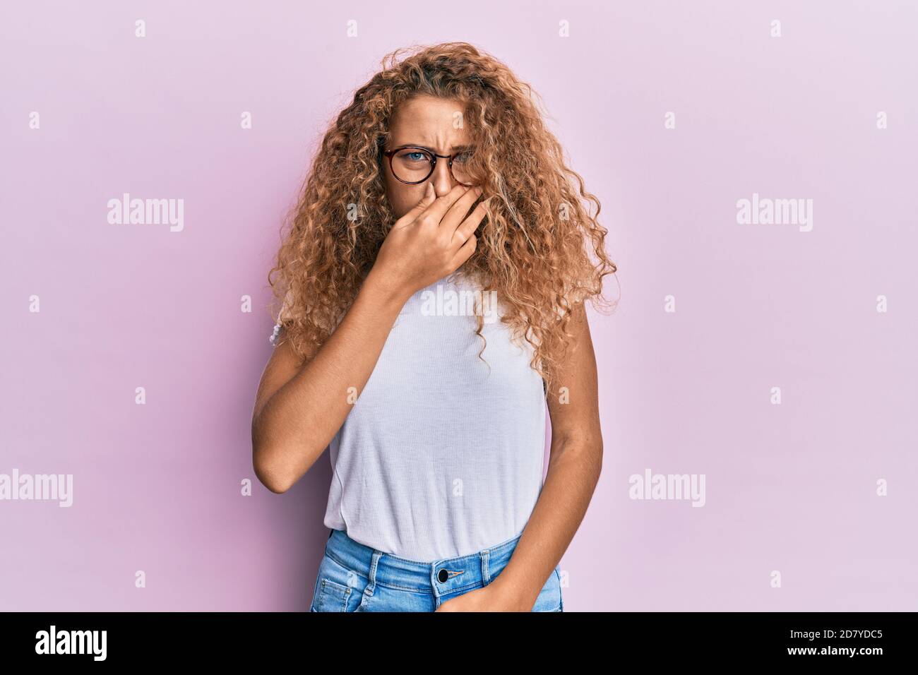 Beautiful caucasian teenager girl wearing white t-shirt over pink ...