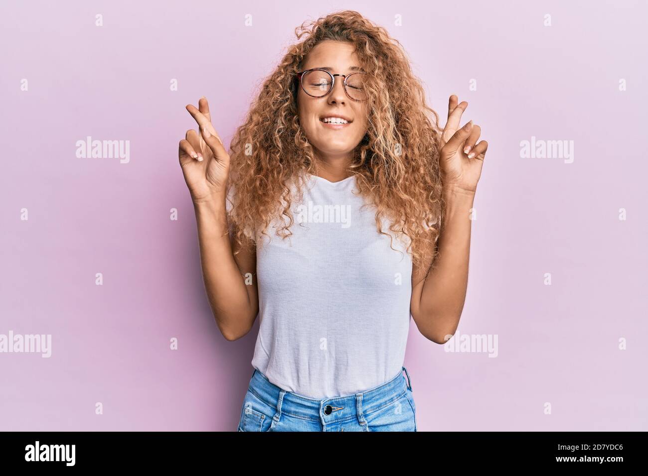 Beautiful caucasian teenager girl wearing white t-shirt over pink ...