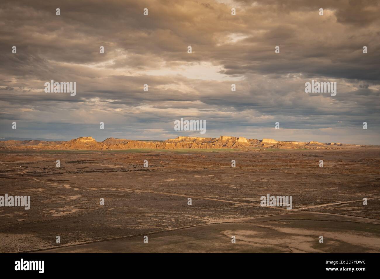 Distant view of arid mountains in the horizon with the sun appearing ...