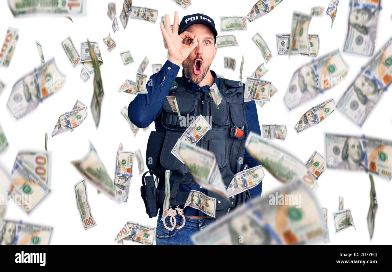 Young handsome man wearing police uniform doing ok gesture shocked with ...