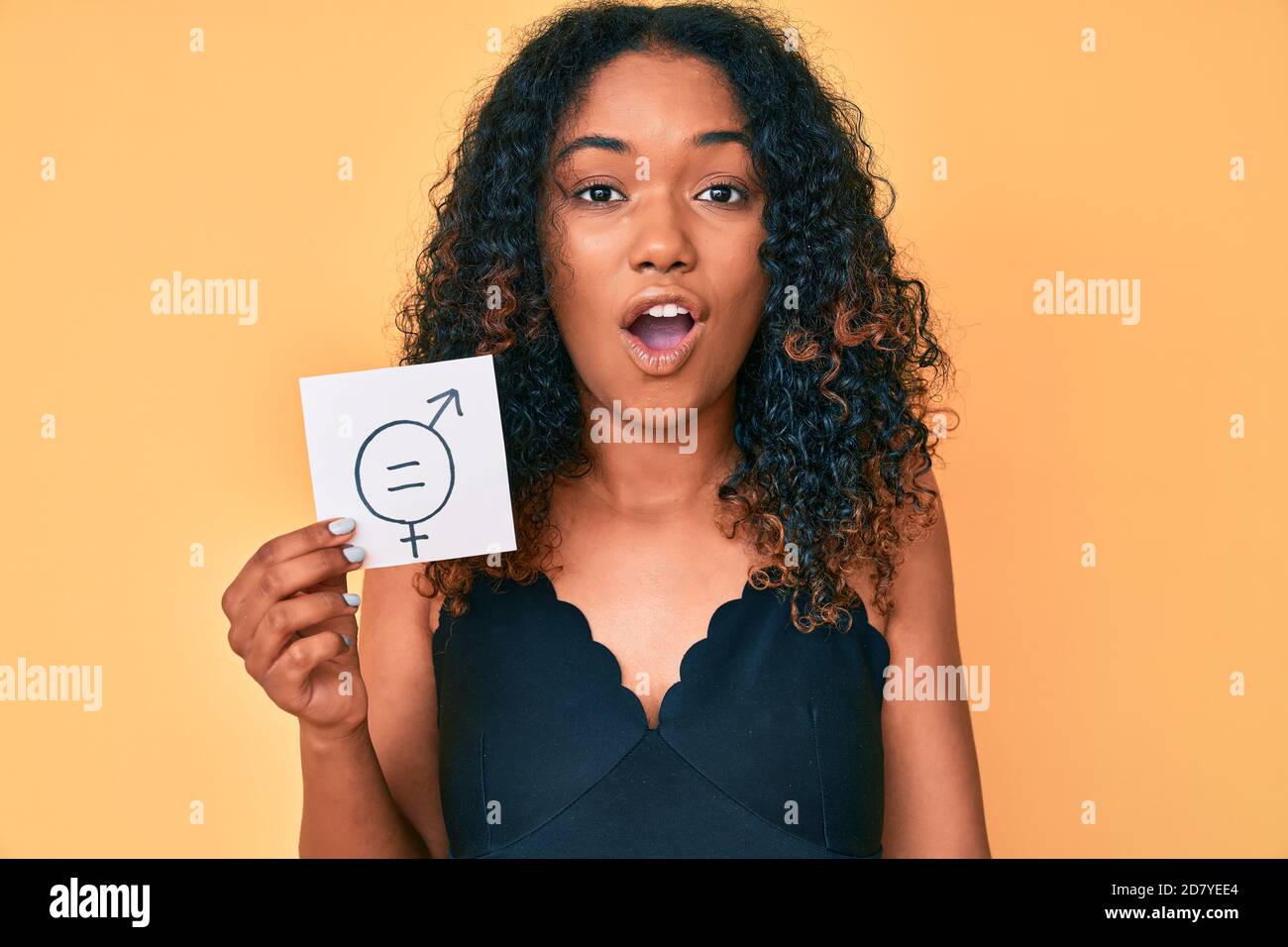 Young african american woman holding we are equal paper scared and ...