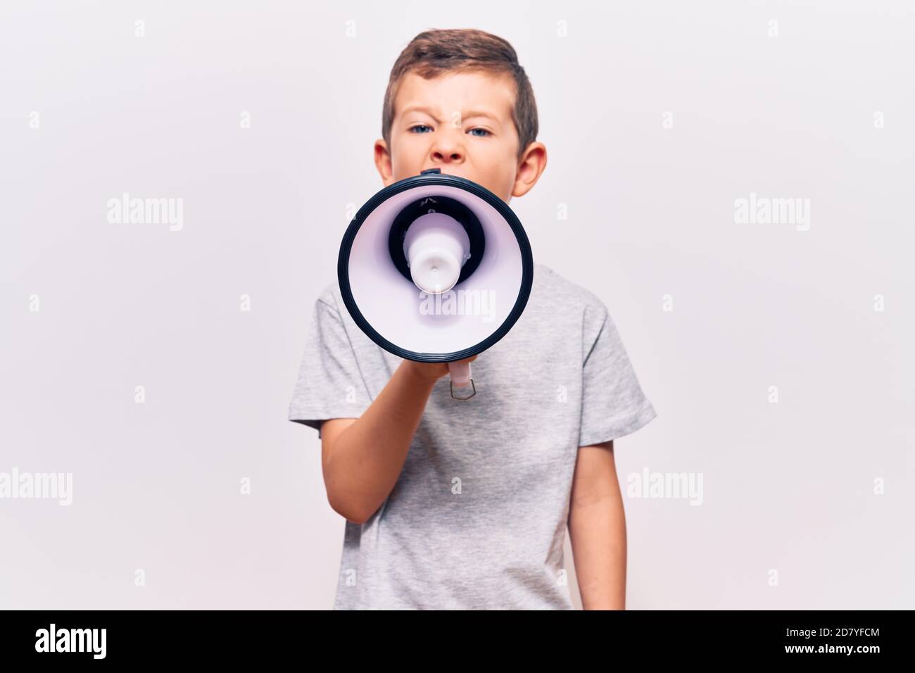 Adorable caucasian kid boy with angry expression. Screaming loud using ...