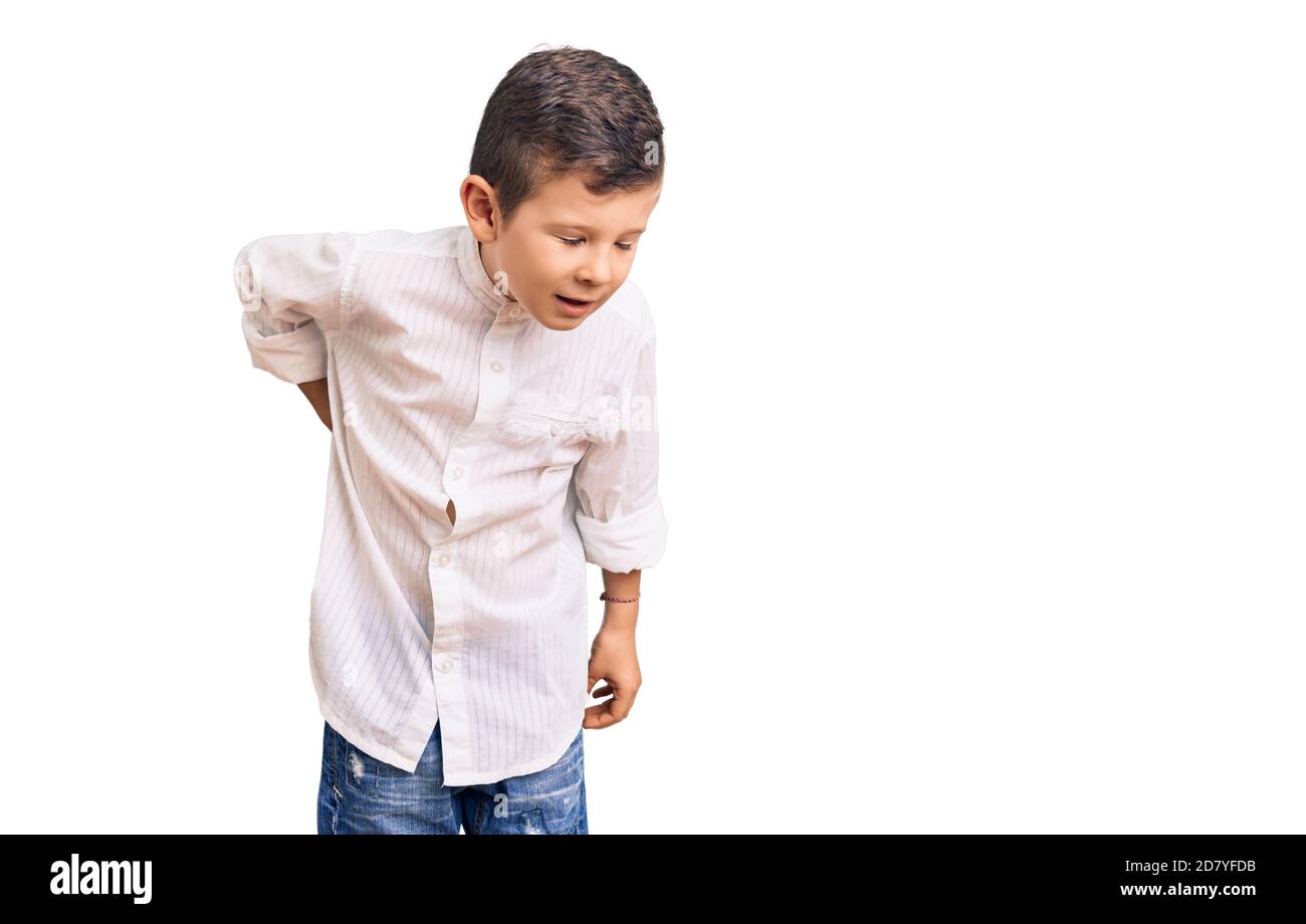 Cute blond kid wearing elegant shirt suffering of backache, touching ...