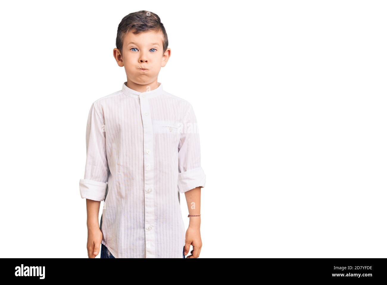 Cute blond kid wearing elegant shirt puffing cheeks with funny face ...