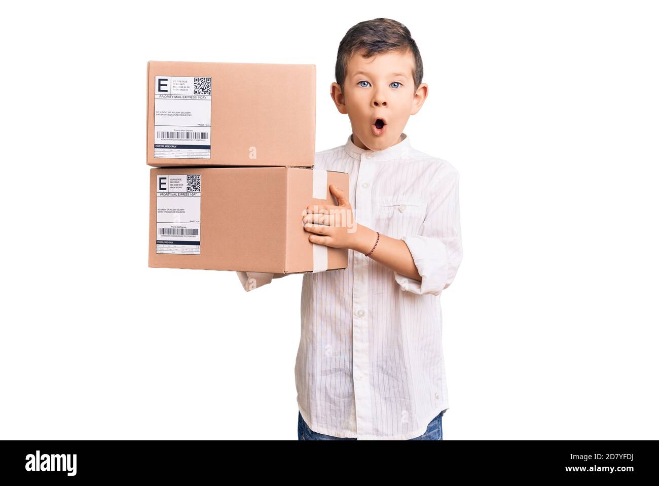 Cute blond kid holding delivery package scared and amazed with open ...