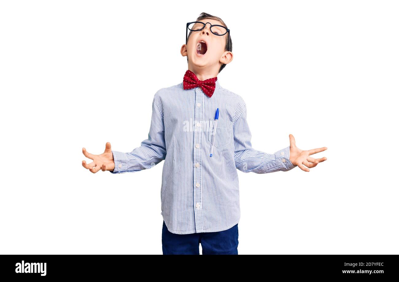 Cute blond kid wearing nerd bow tie and glasses crazy and mad shouting ...