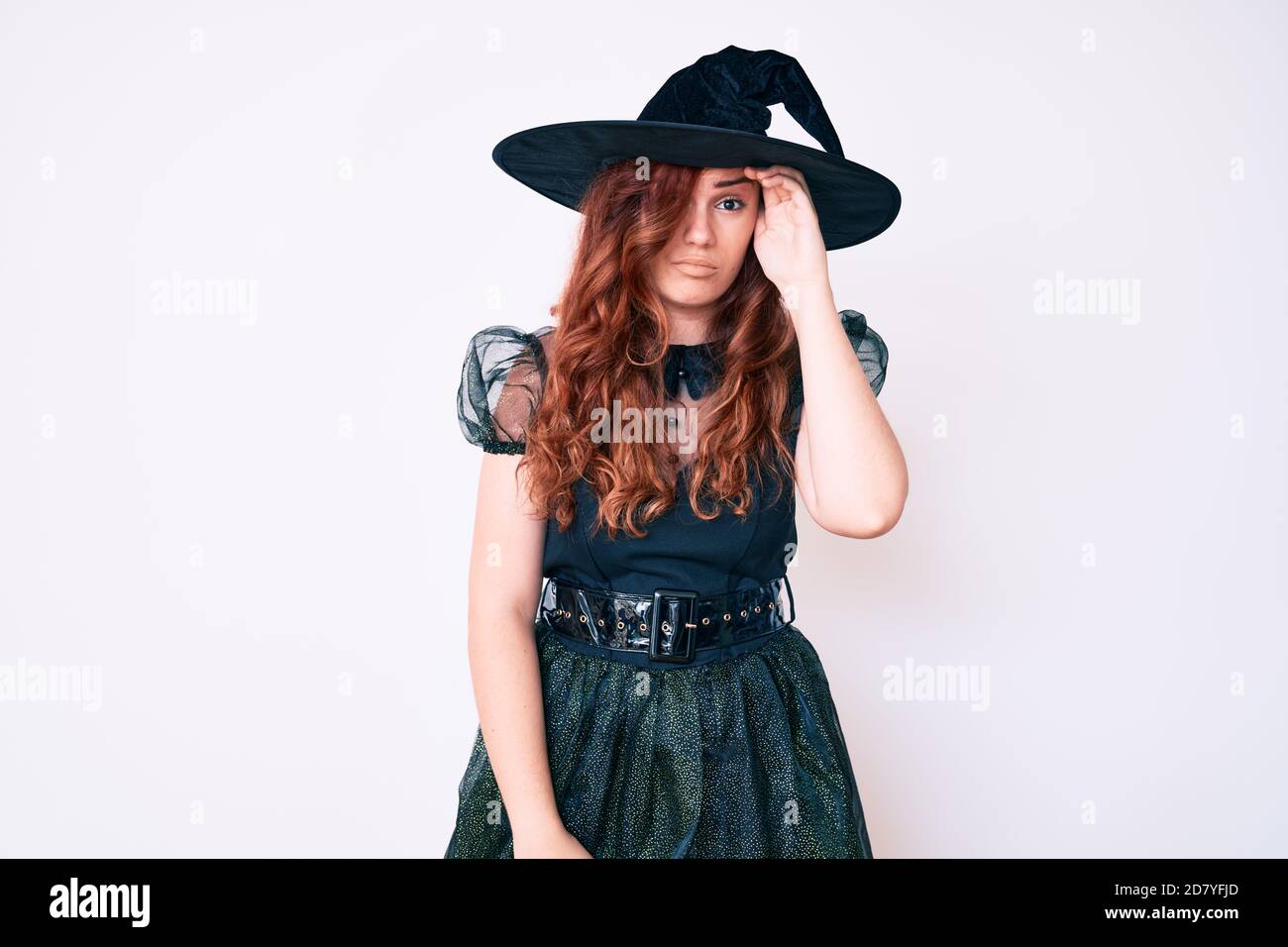 Young beautiful woman wearing witch halloween costume worried and ...