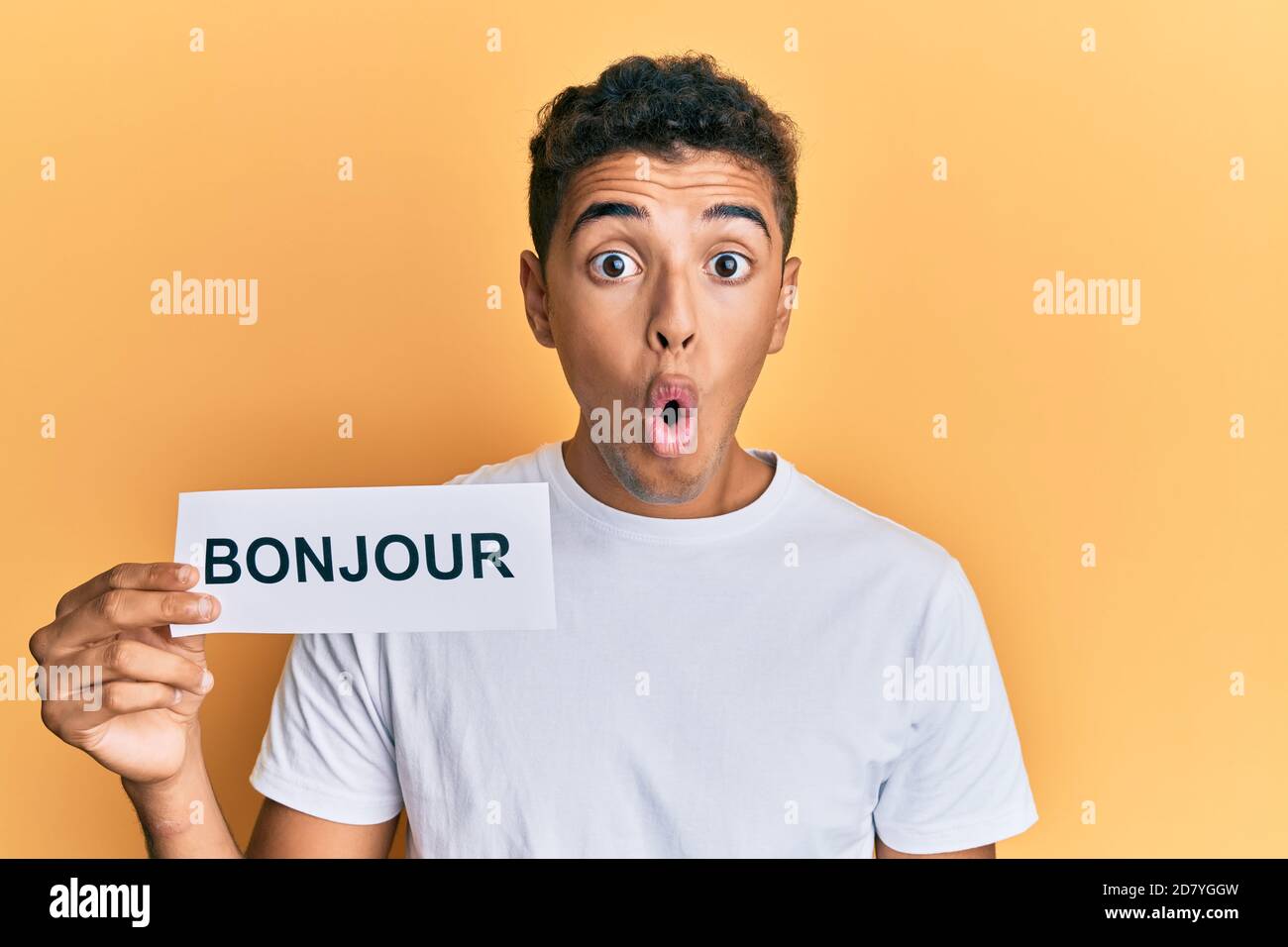 Young handsome african american man holding bonjour french greeting ...