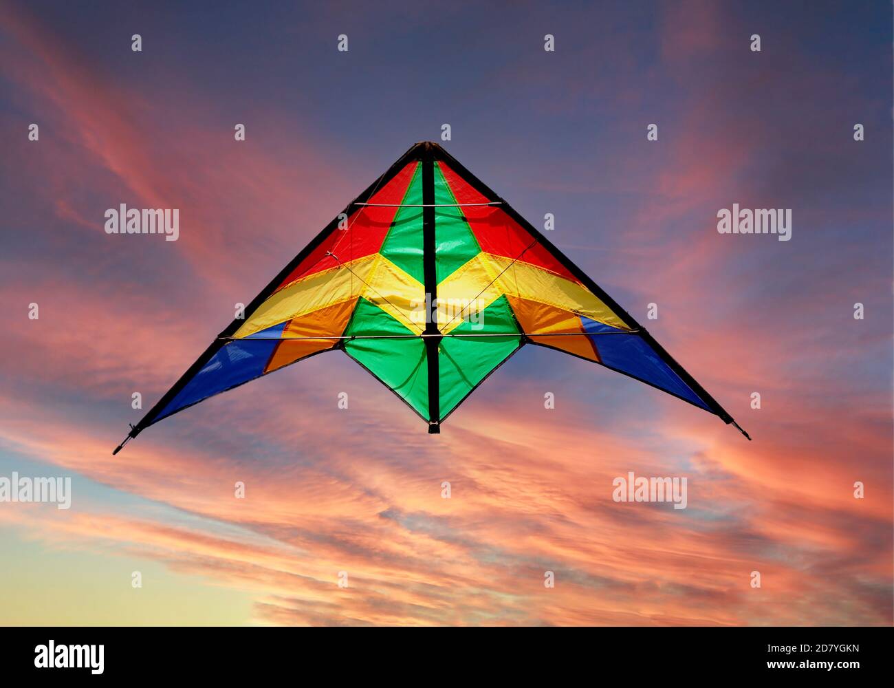 Colored kite flying in the middle of a beaurtiful sunset Stock Photo ...