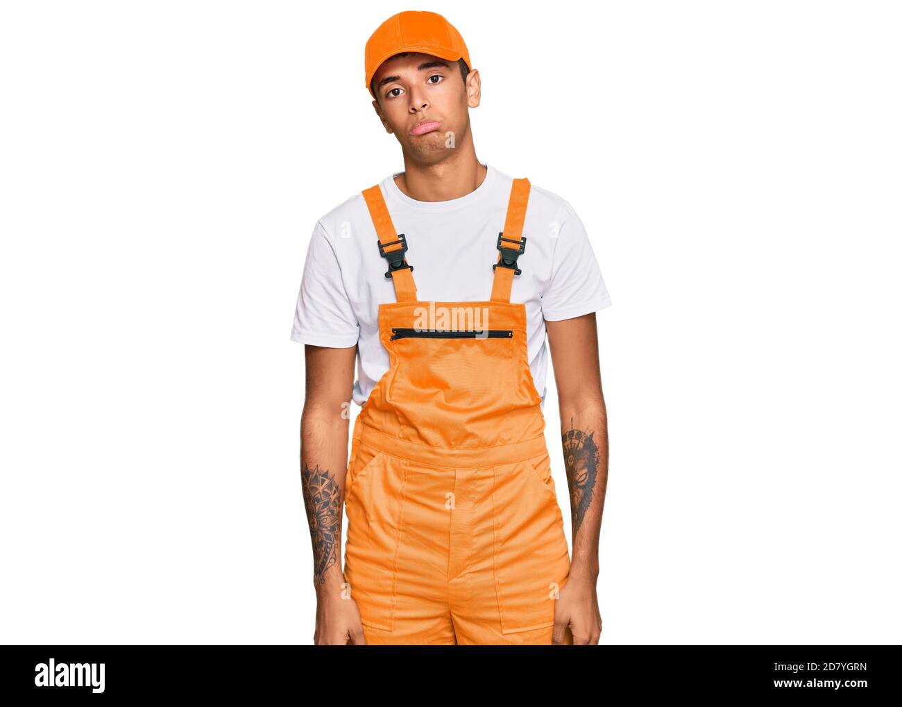 Young handsome african american man wearing handyman uniform depressed ...