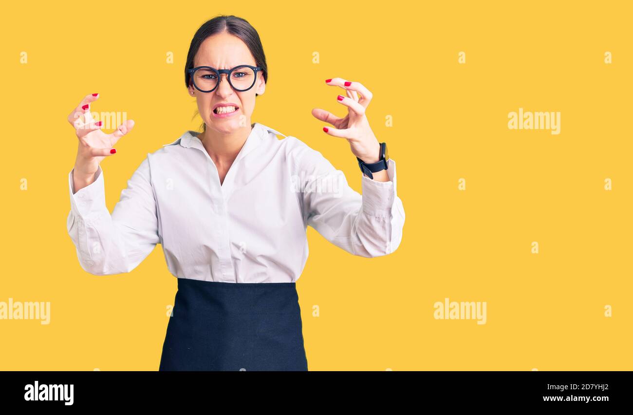 Beautiful brunette young woman wearing professional waitress apron ...