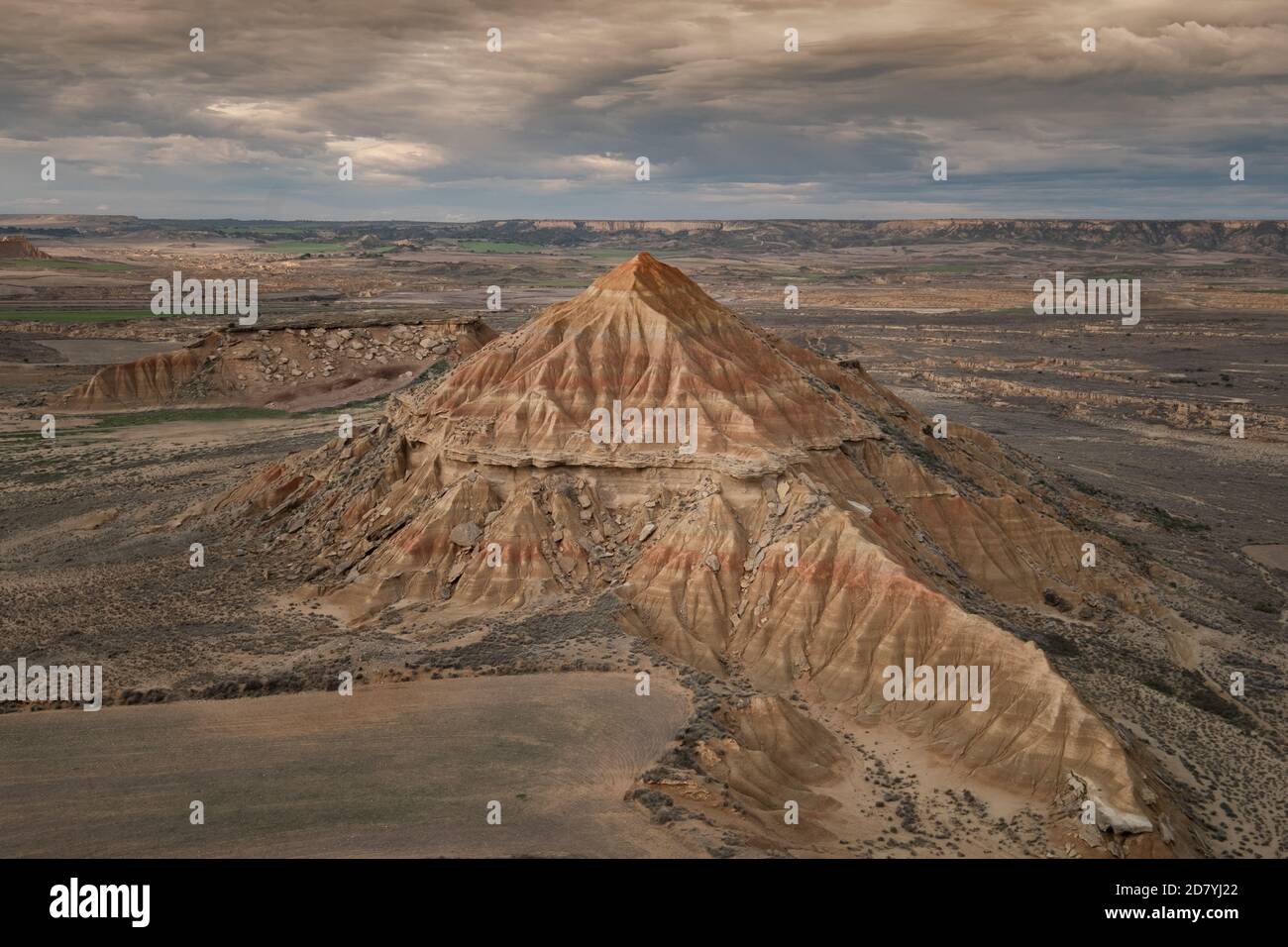 Landscape aerial view of an arid and isolated mountain in a cloudy ...