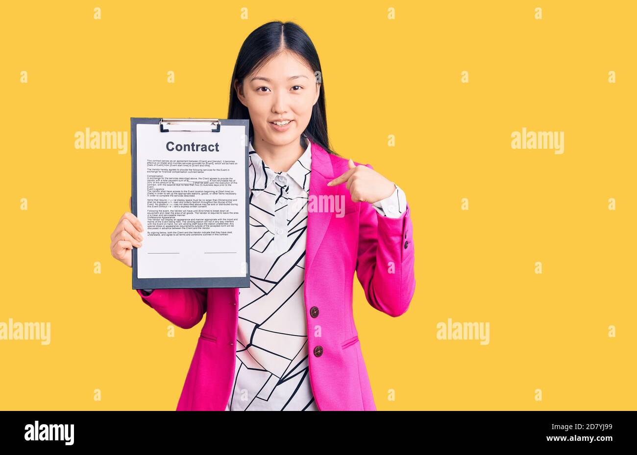 Young beautiful chinese woman holding clipboard with contract document ...