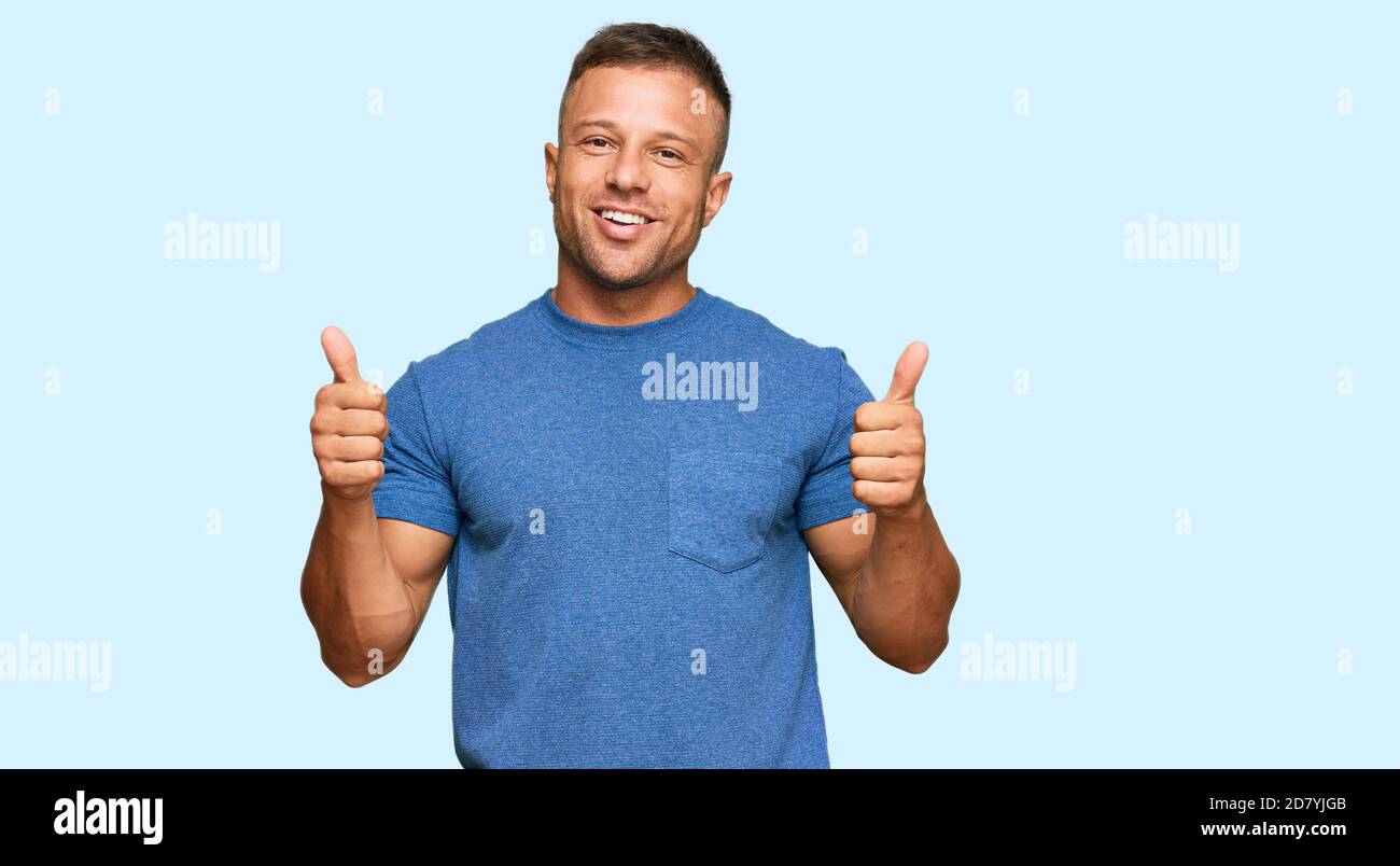 Handsome muscle man wearing casual clothes success sign doing positive ...