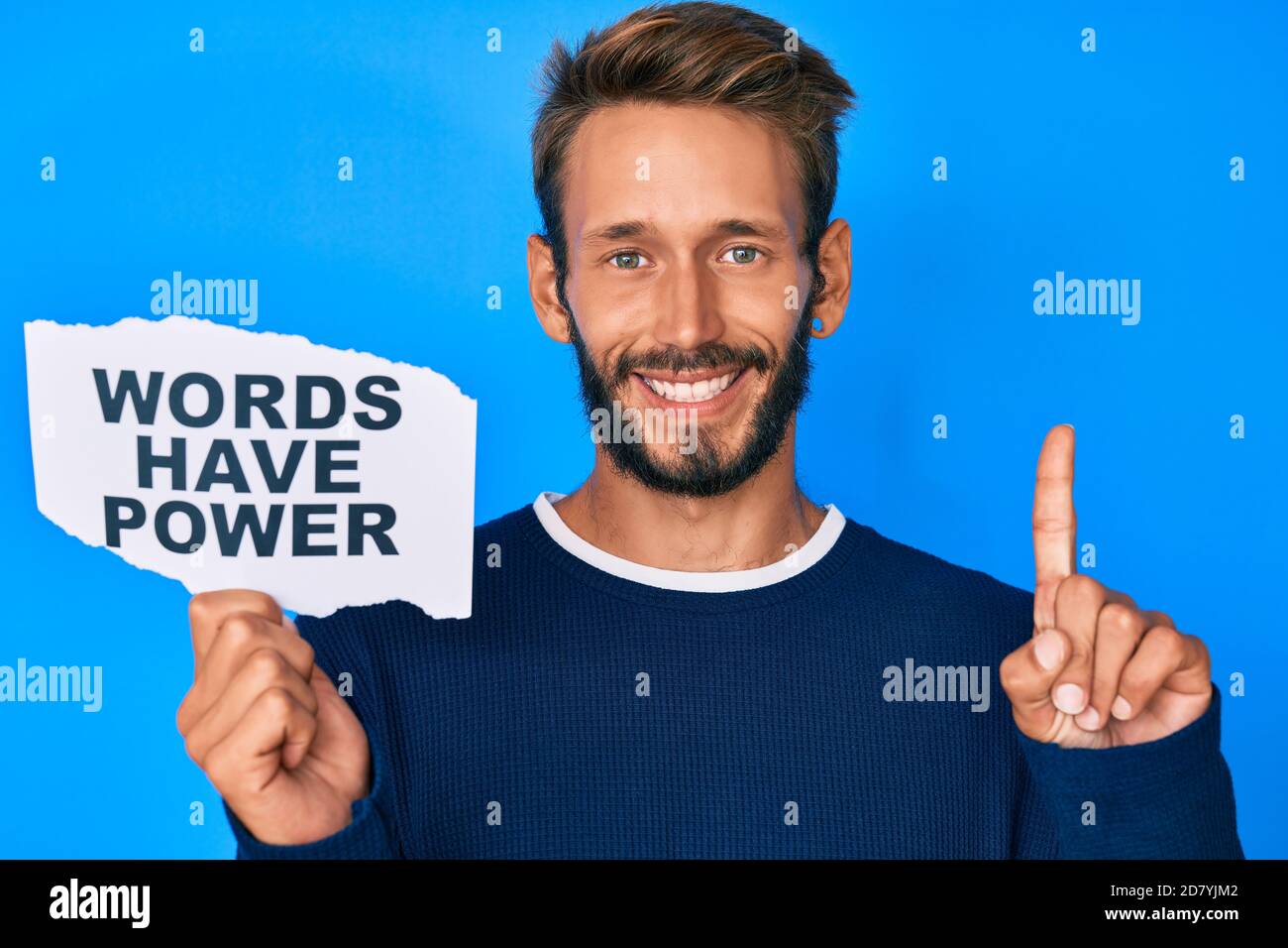 Handsome caucasian man with beard showing words have power banner ...