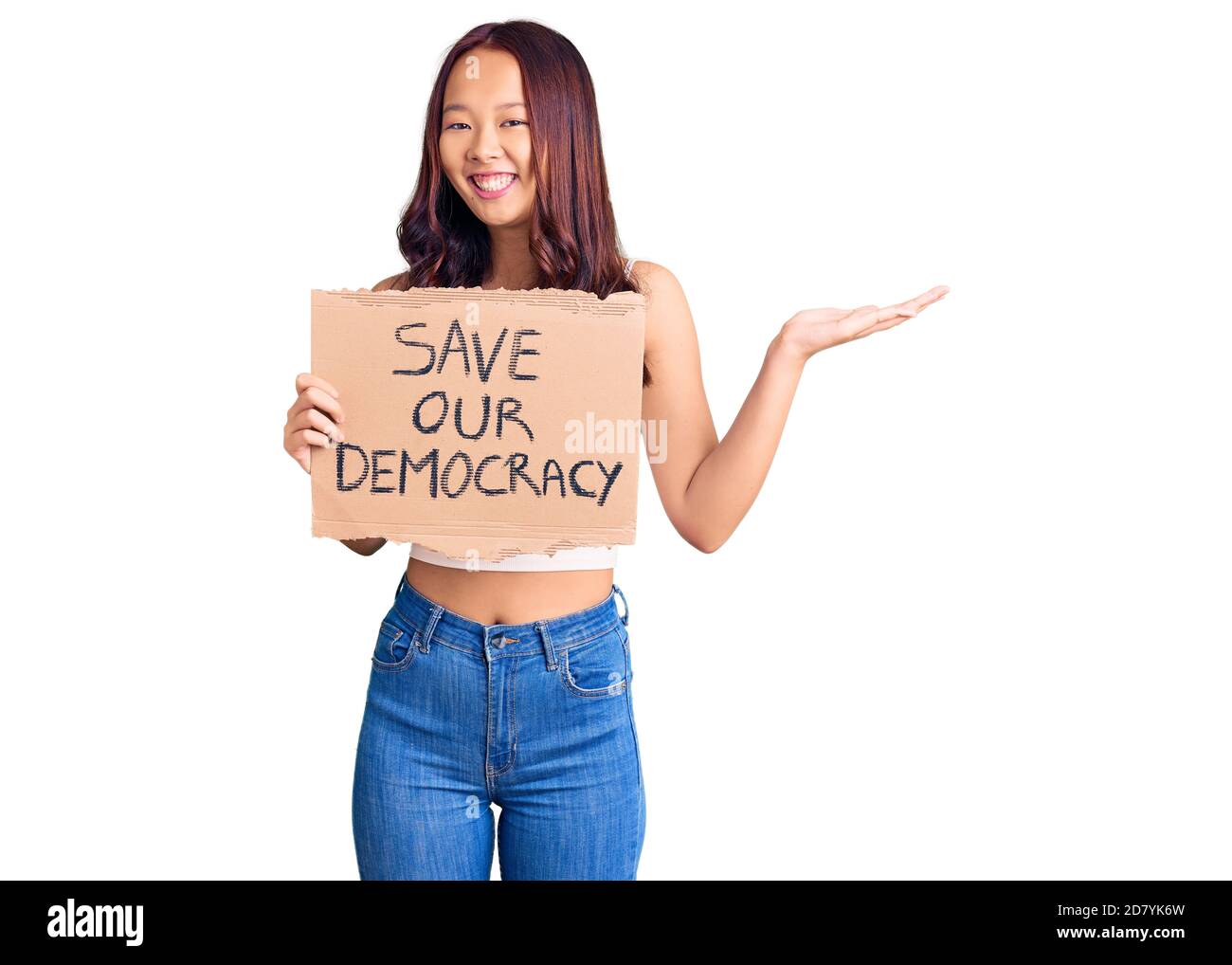 Young beautiful chinese girl holding save our democracy protest banner ...