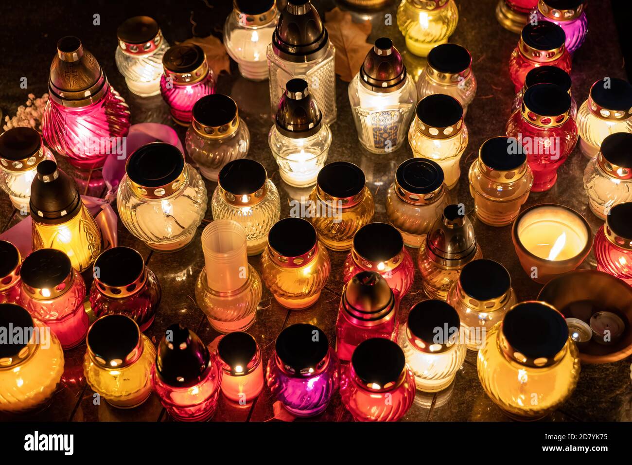 Candle lights at night on cemetery tombstone on All Saints Day Stock ...