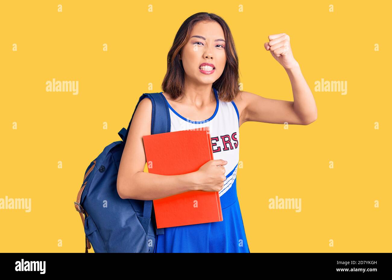 Young beautiful chinese girl wearing cheerleader uniform and student ...
