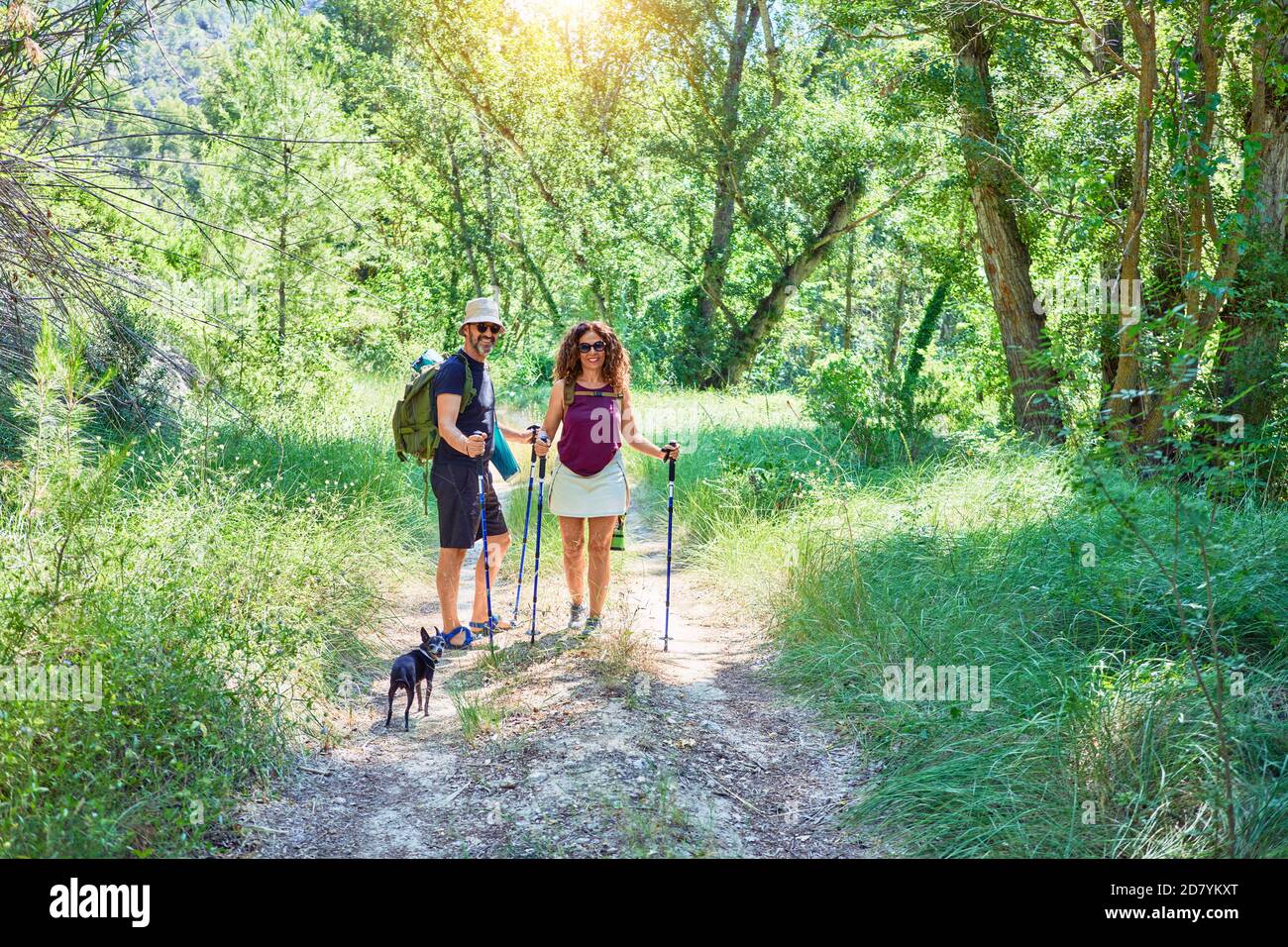Beautiful couple of hiker wearing backpack smiling happy. Standing with ...