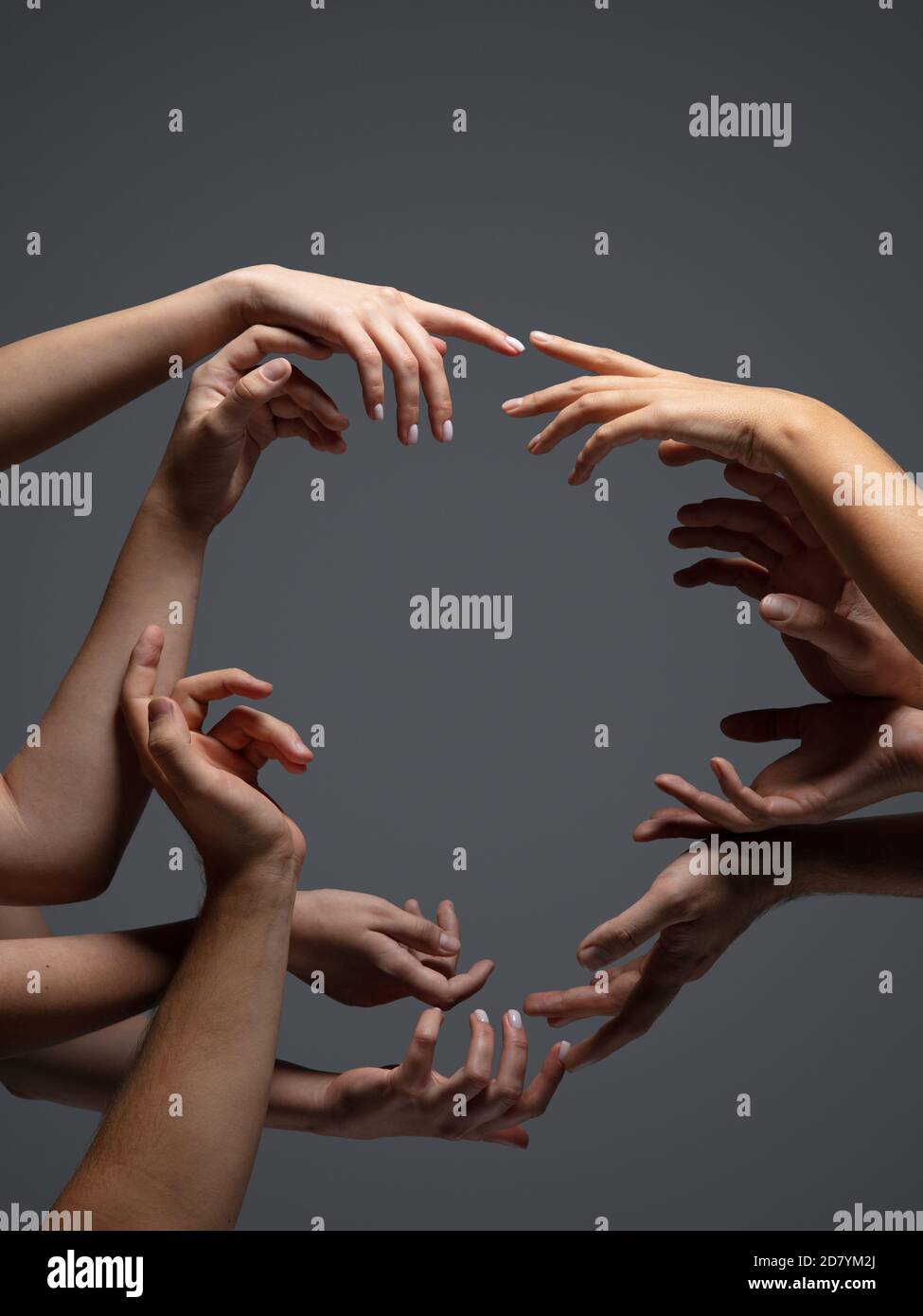 Rounded. Hands of people's crows in touch isolated on grey studio ...