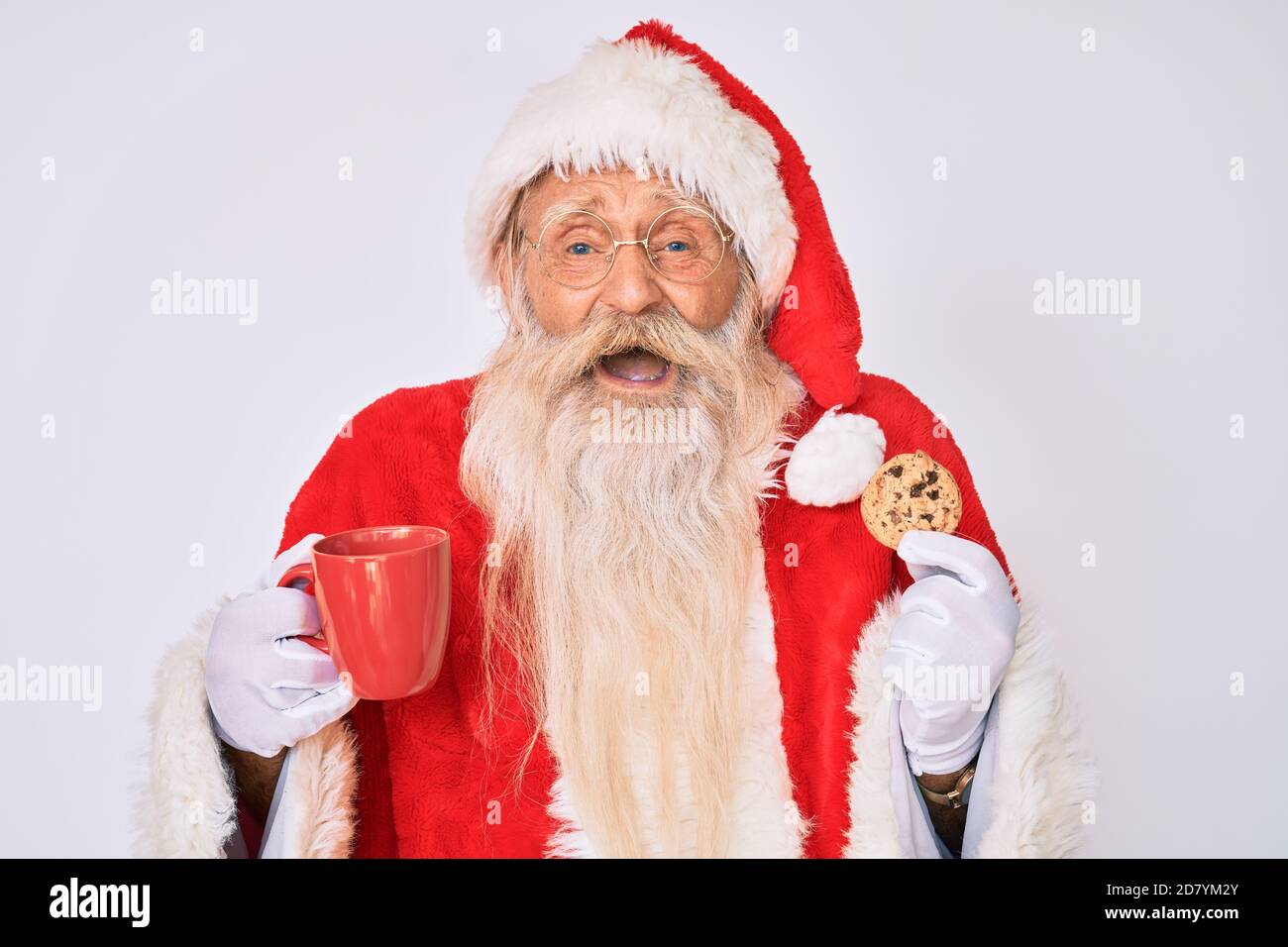 Old senior man with grey hair and long beard wearing santa claus ...