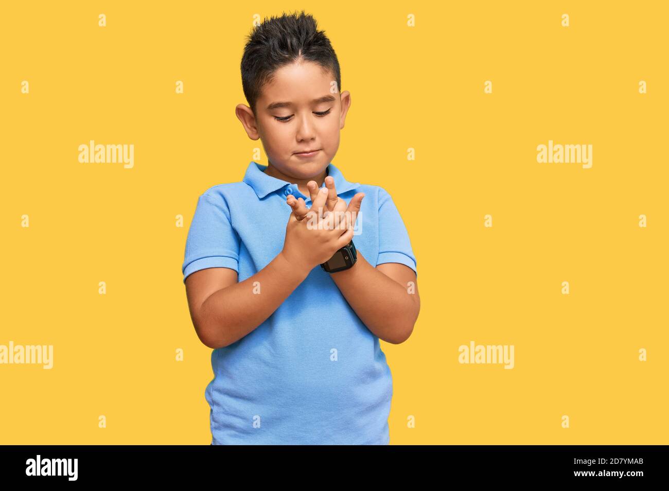 Little boy hispanic kid wearing casual clothes suffering pain on hands ...