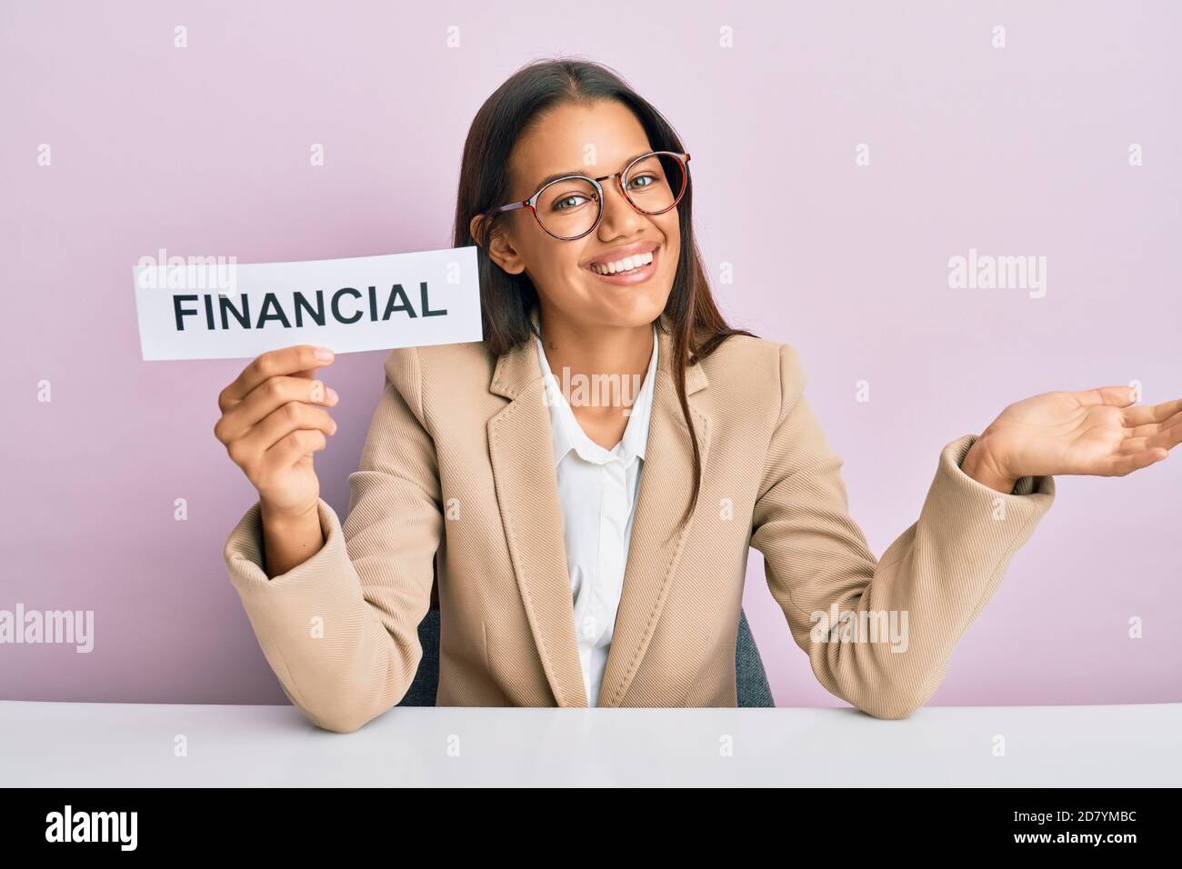 Beautiful hispanic business woman holding financial message paper ...