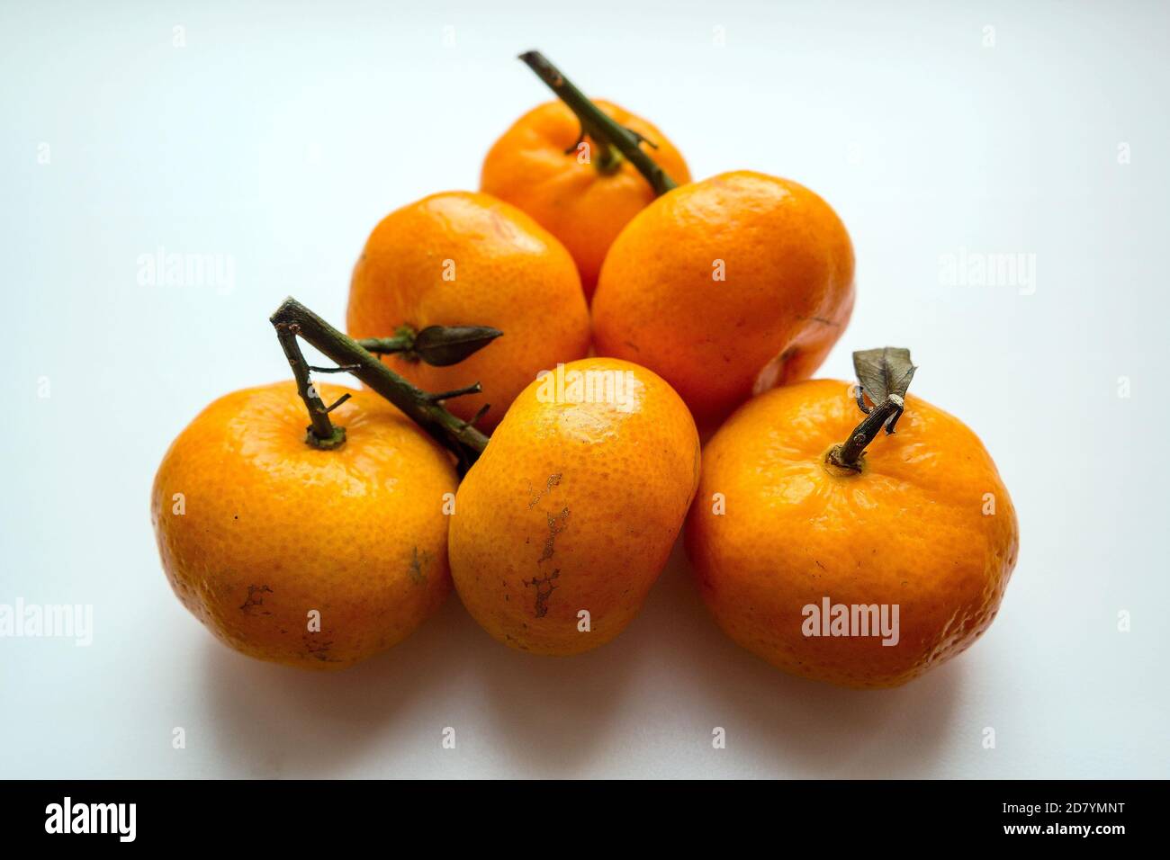 Pile of mandarins with leaf on white background Stock Photo - Alamy