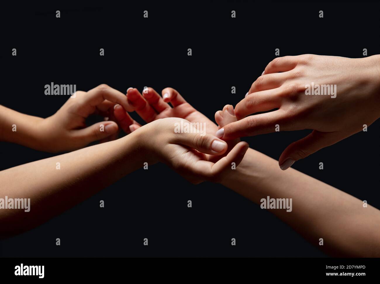 Family. Hands of people's crows in touch isolated on black studio ...