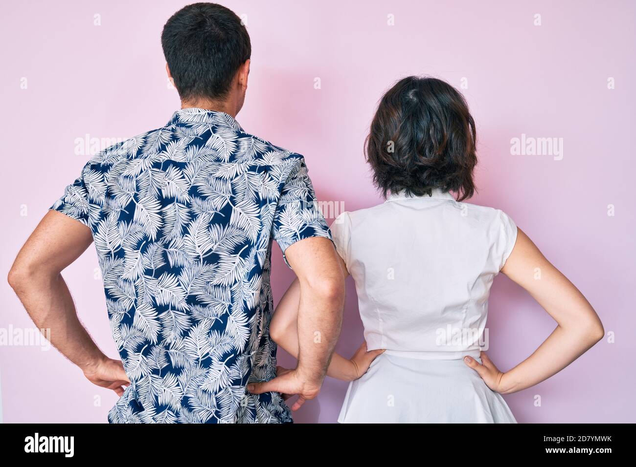 Beautiful couple wearing casual clothes standing backwards looking away ...